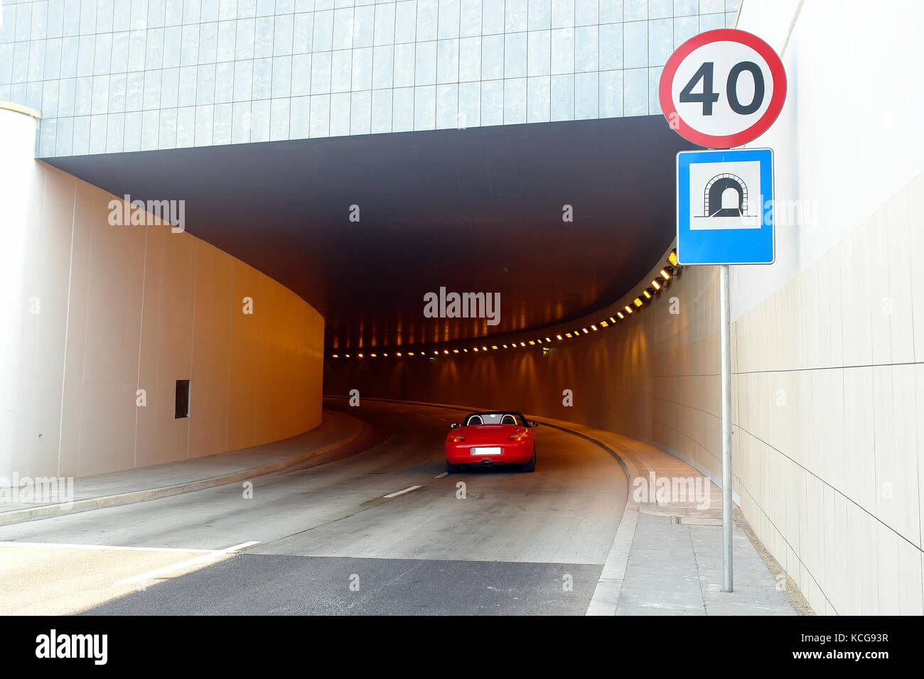 Red sports car entering tunnel Stock Photo - Alamy
