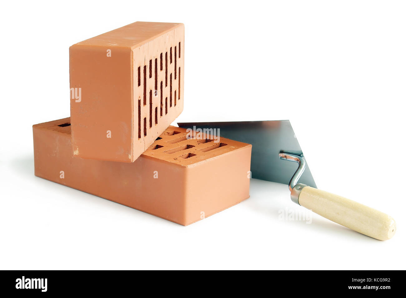 Two perforated bricks and stainless steel trowel isolated on white ...