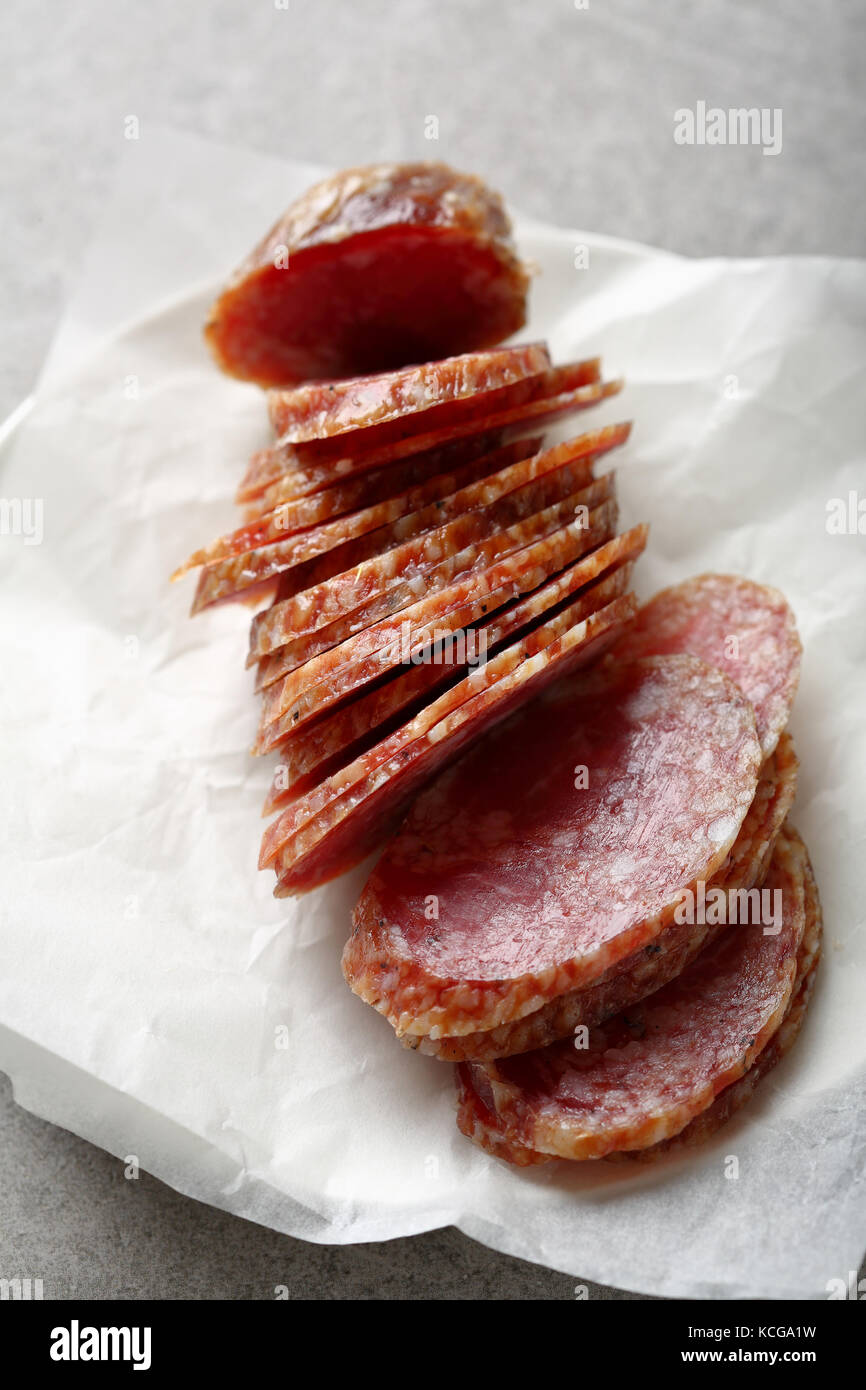 Sliced Salami on loft table, food closeup Stock Photo - Alamy