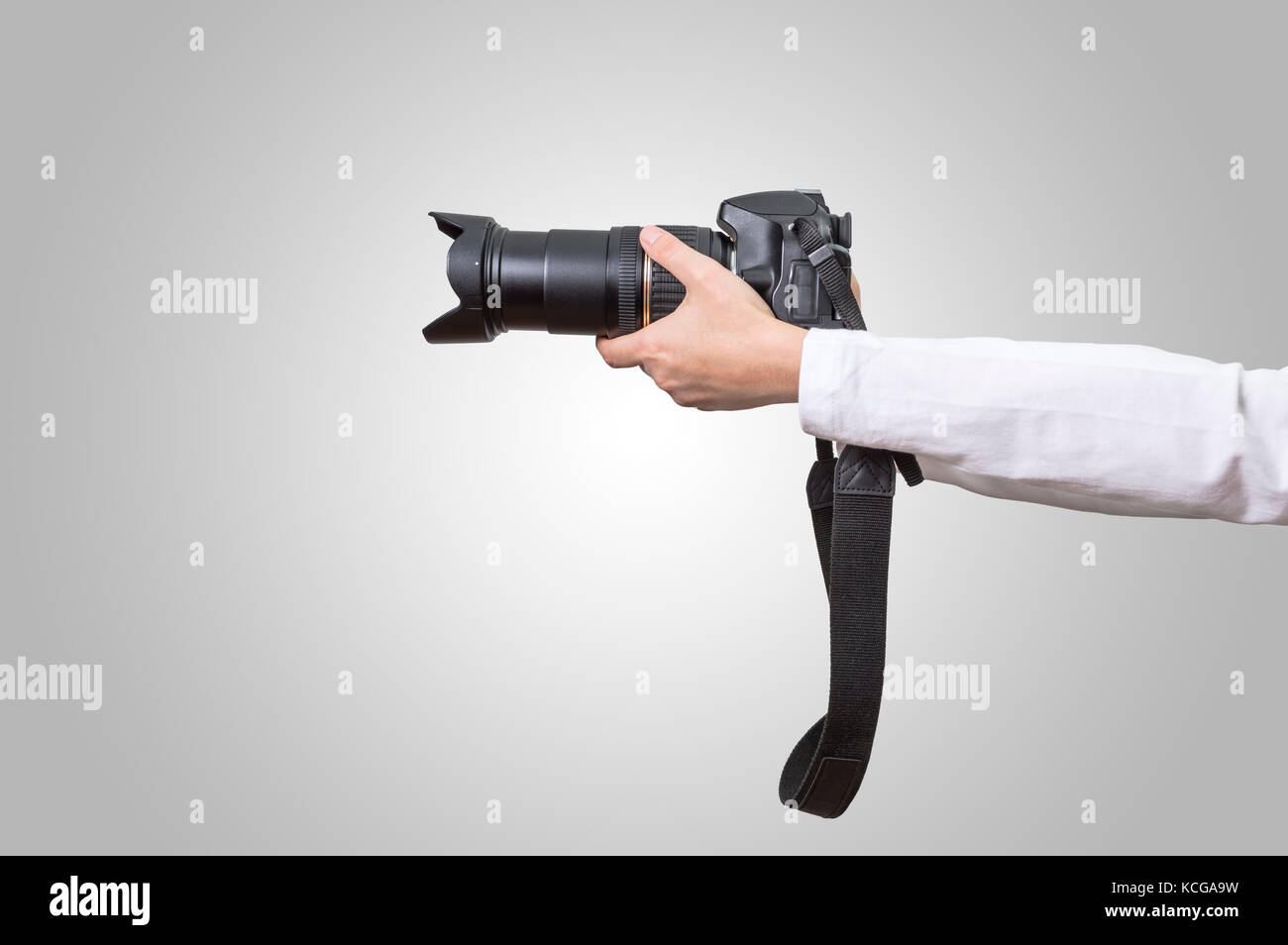 Photo camera in hand isolated on light background Stock Photo - Alamy