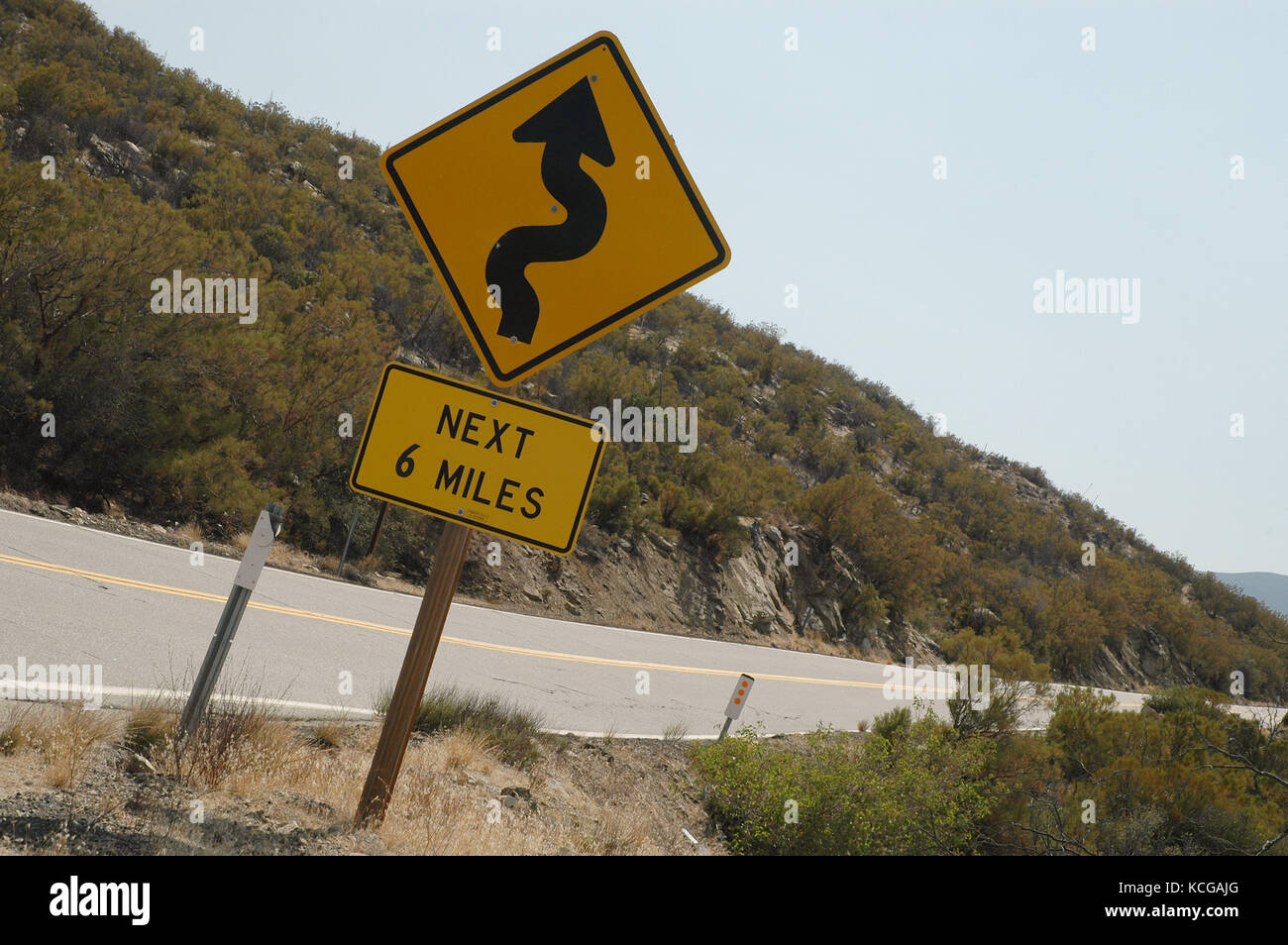 Warning sign of bends on a highway in California Stock Photo - Alamy