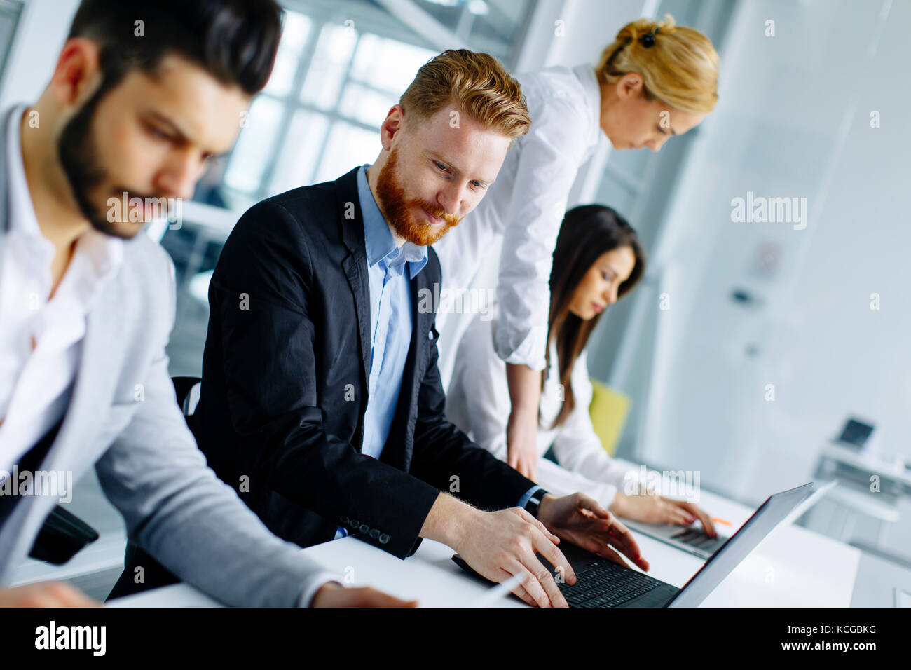 Business team working together in modern office to achieve better ...