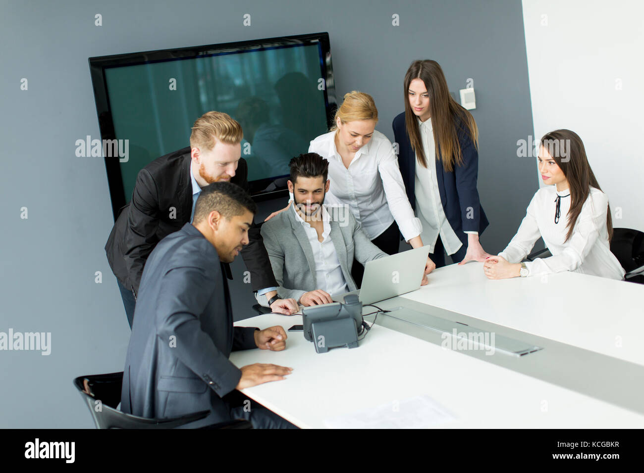 Business team working together in modern office to achieve better ...