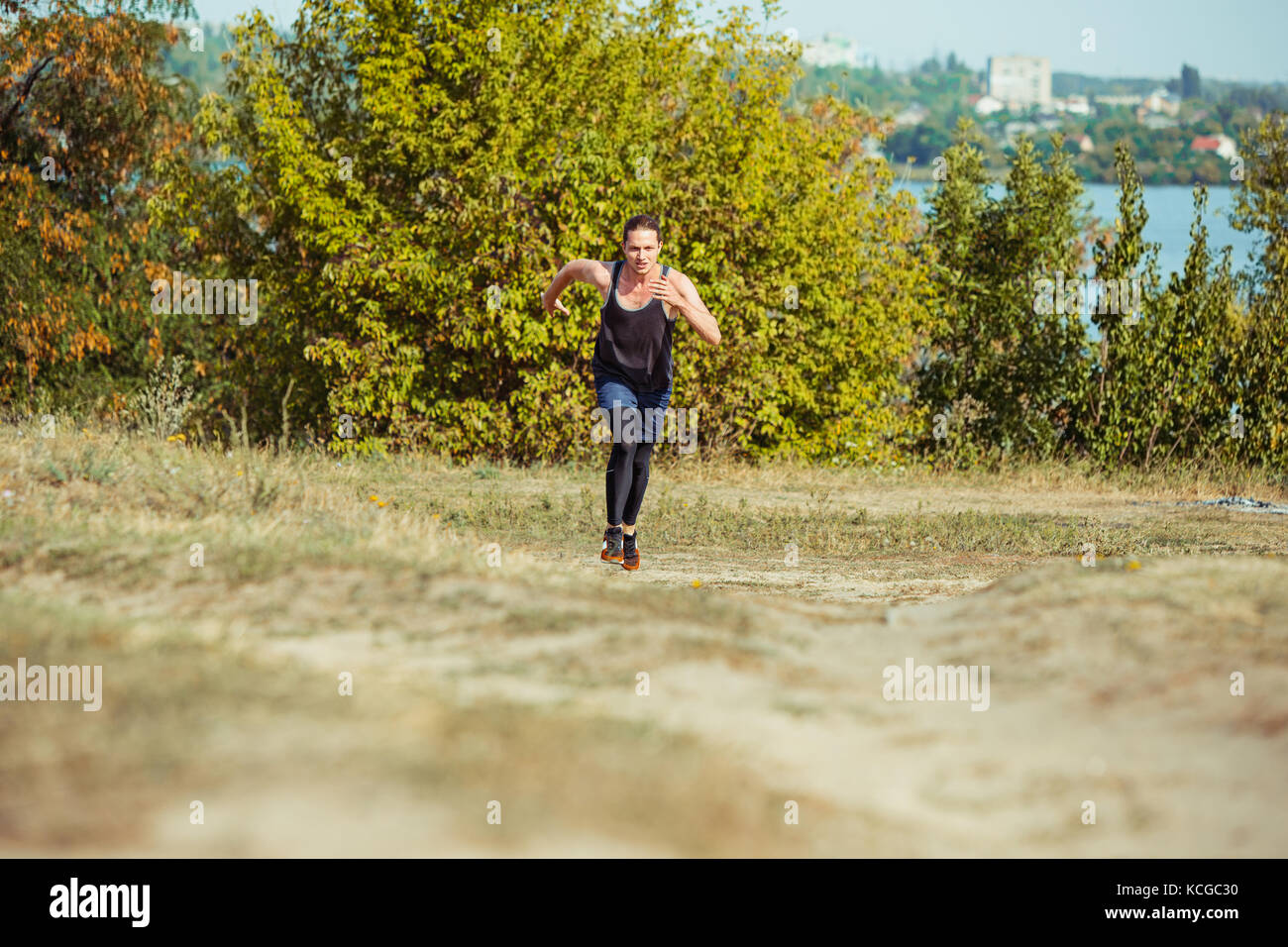 Running sport. Man runner sprinting outdoor in scenic nature. Fit ...