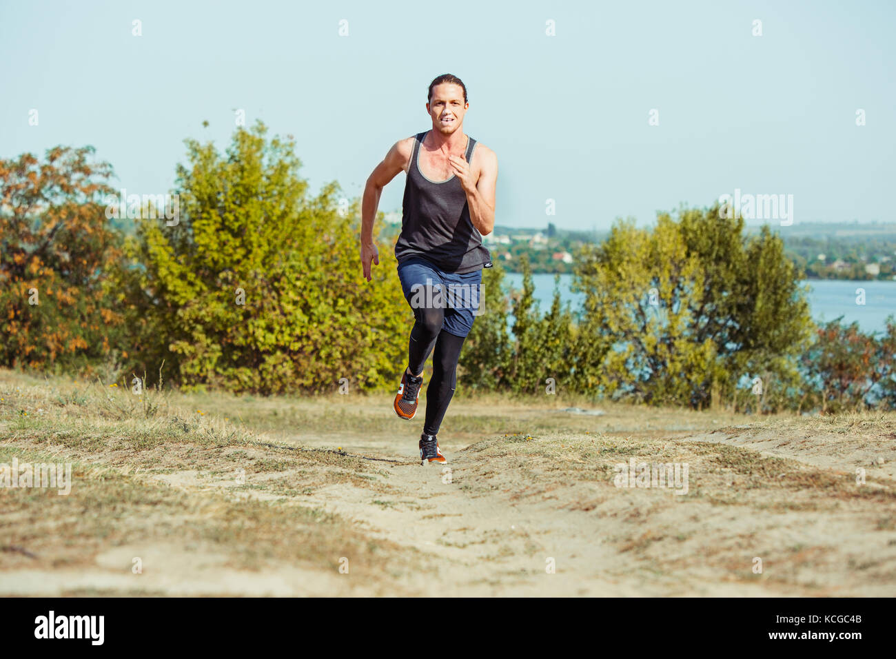Running sport. Man runner sprinting outdoor in scenic nature. Fit ...