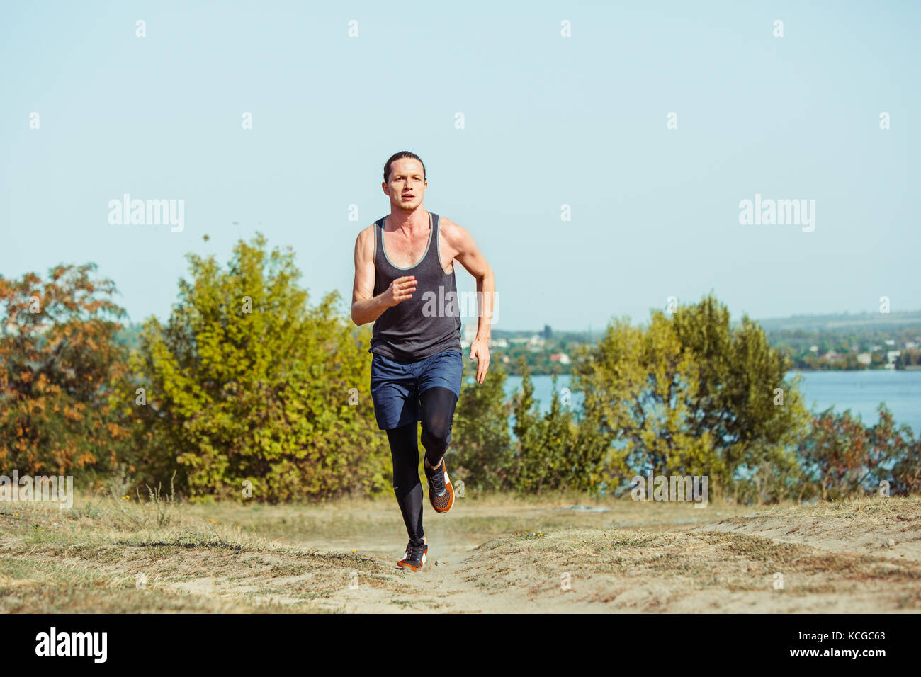 Running sport. Man runner sprinting outdoor in scenic nature. Fit ...