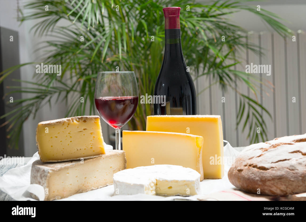 Different french cheeses with a glass of red wine Stock Photo - Alamy