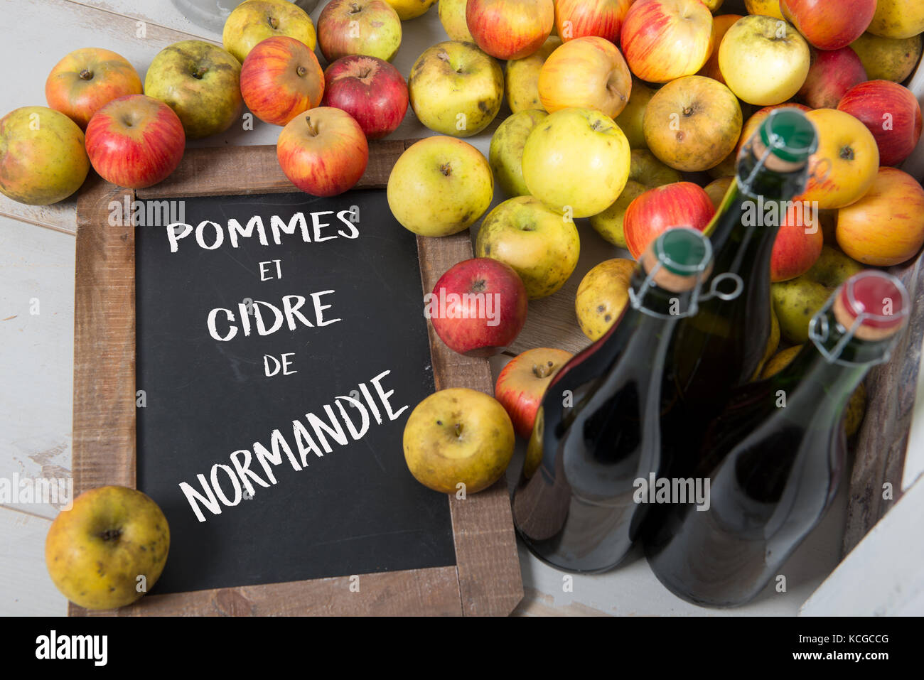 composition of organic fresh apples and bottle of Normandy cider with ...
