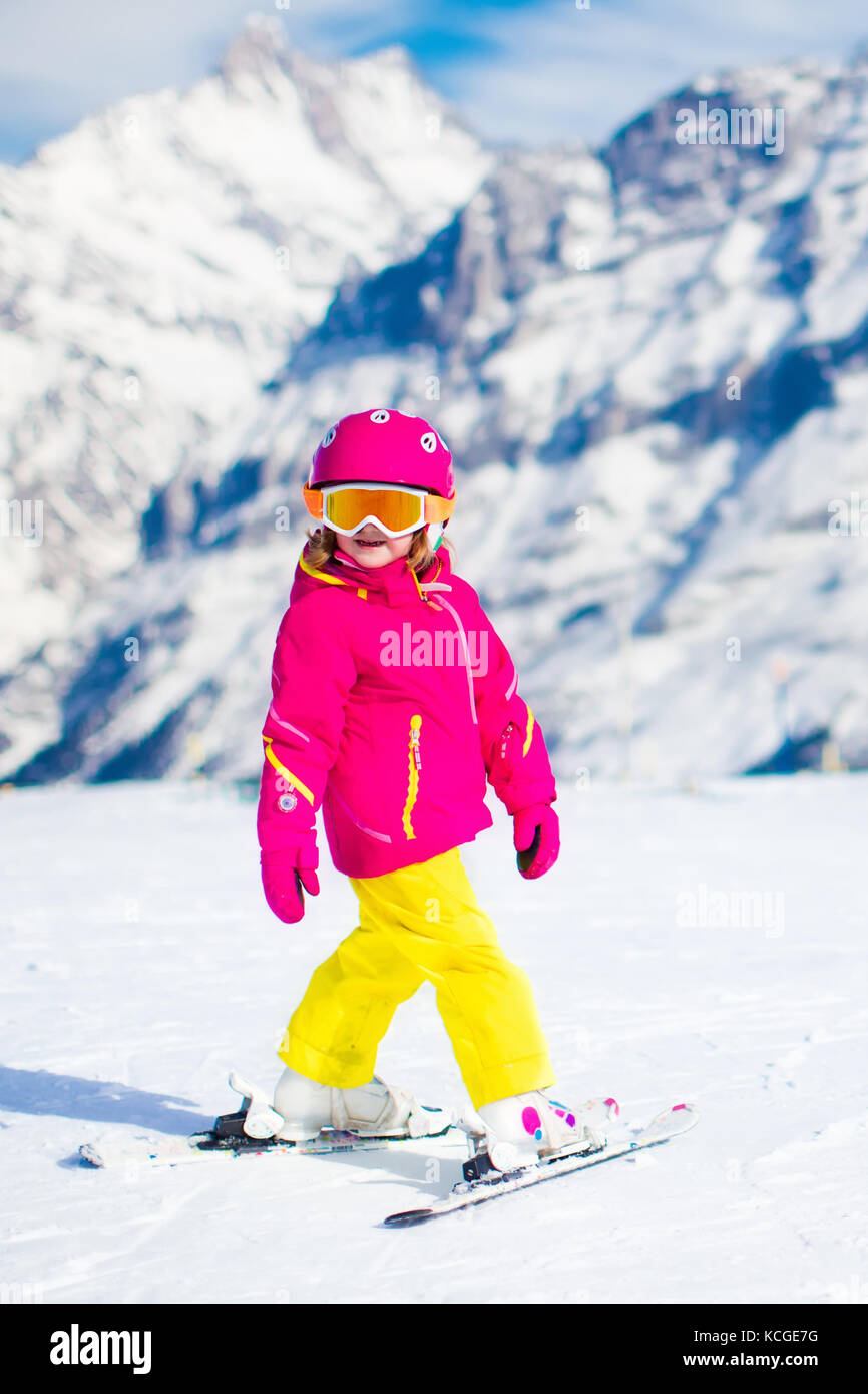 Child skiing in mountains. Active toddler kid with safety helmet ...