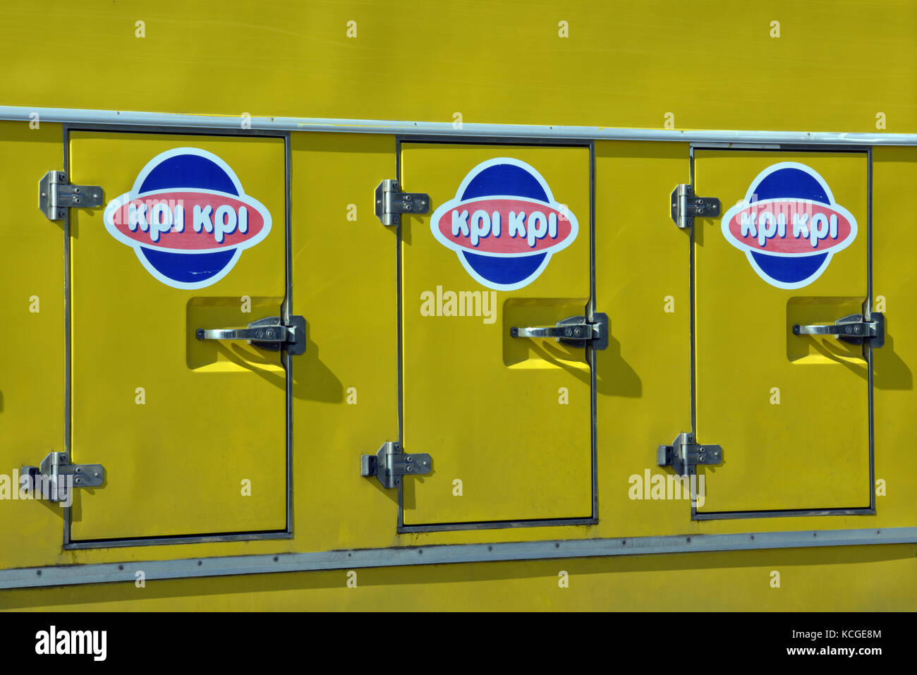 A row of three yellow brightly coloured fridges or refrigeration ...