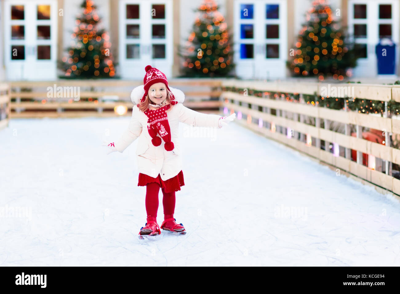 Kids ice skating in winter park rink. Children ice skate on Christmas ...