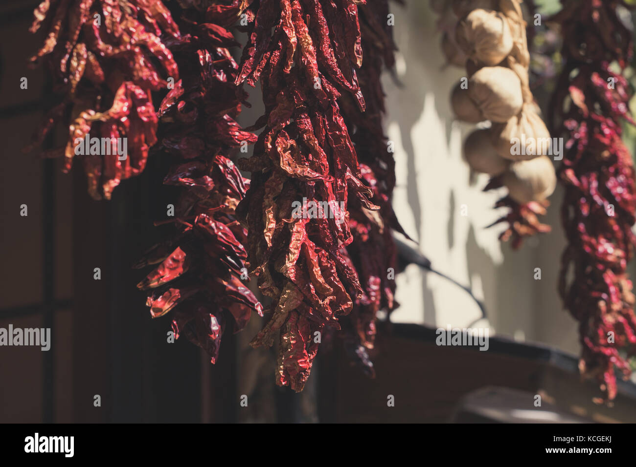 Hanging bunches of dry chili peppers Stock Photo - Alamy