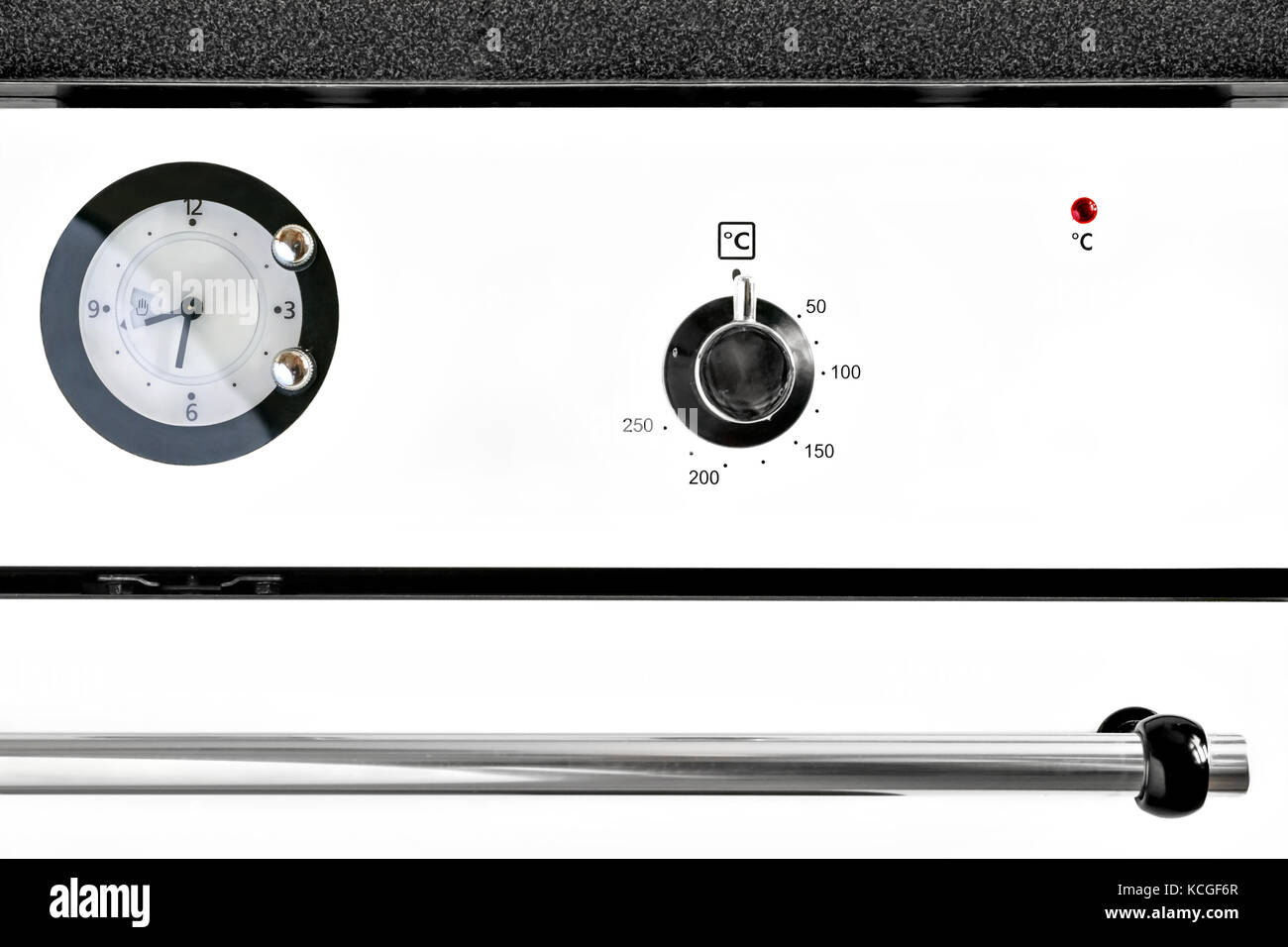 Fragment of a white panel internal oven with clock, temperature ...