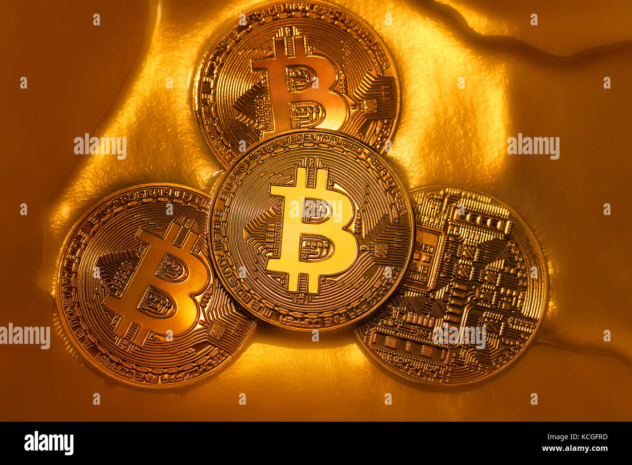 Bitcoin gold coins on a gold background Stock Photo - Alamy