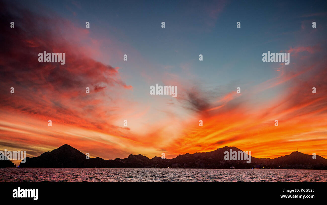 Sunset with a stunning beautiful sky above the city of Cabo San Lucas ...