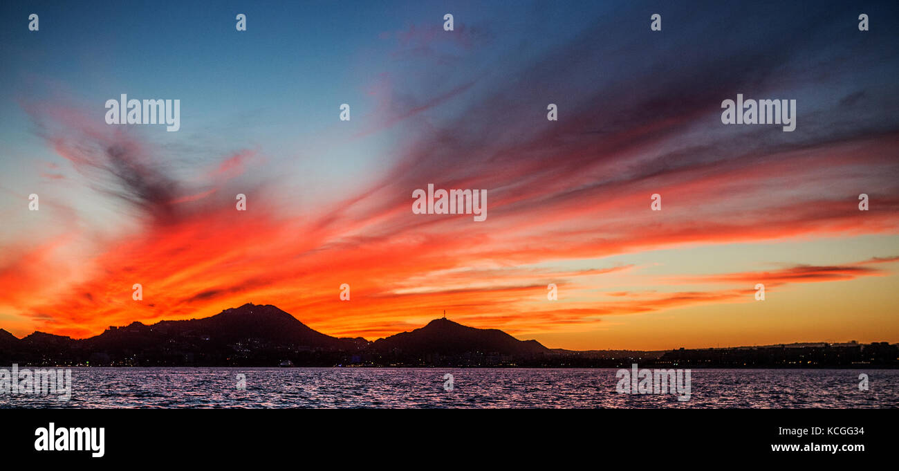 Sunset with a stunning beautiful sky above the city of Cabo San Lucas ...