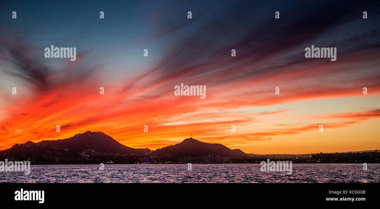 Sunset with a stunning beautiful sky above the city of Cabo San Lucas ...