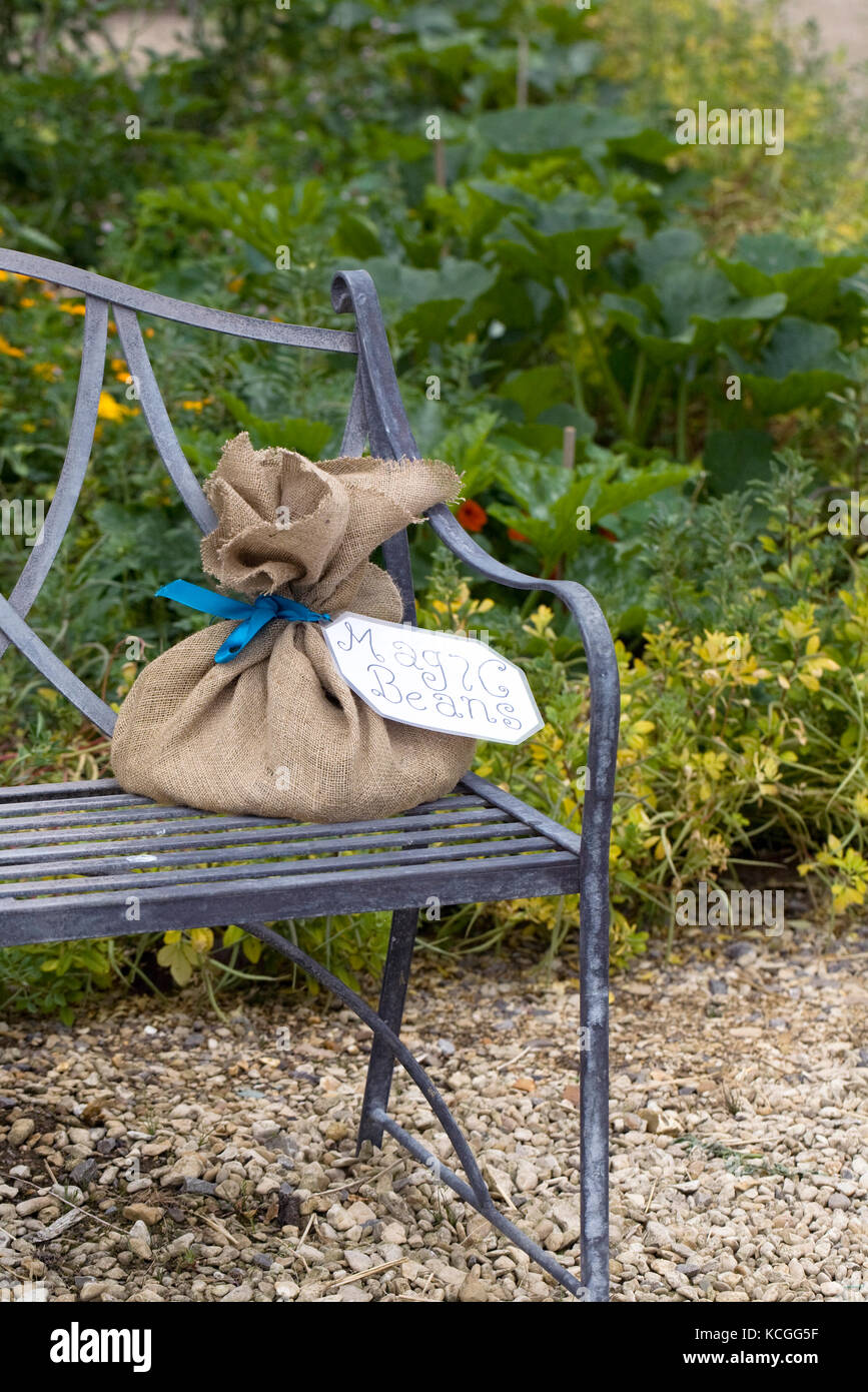 A bag of Magic Beans on a garden bench at Waterperry Gardens Stock ...