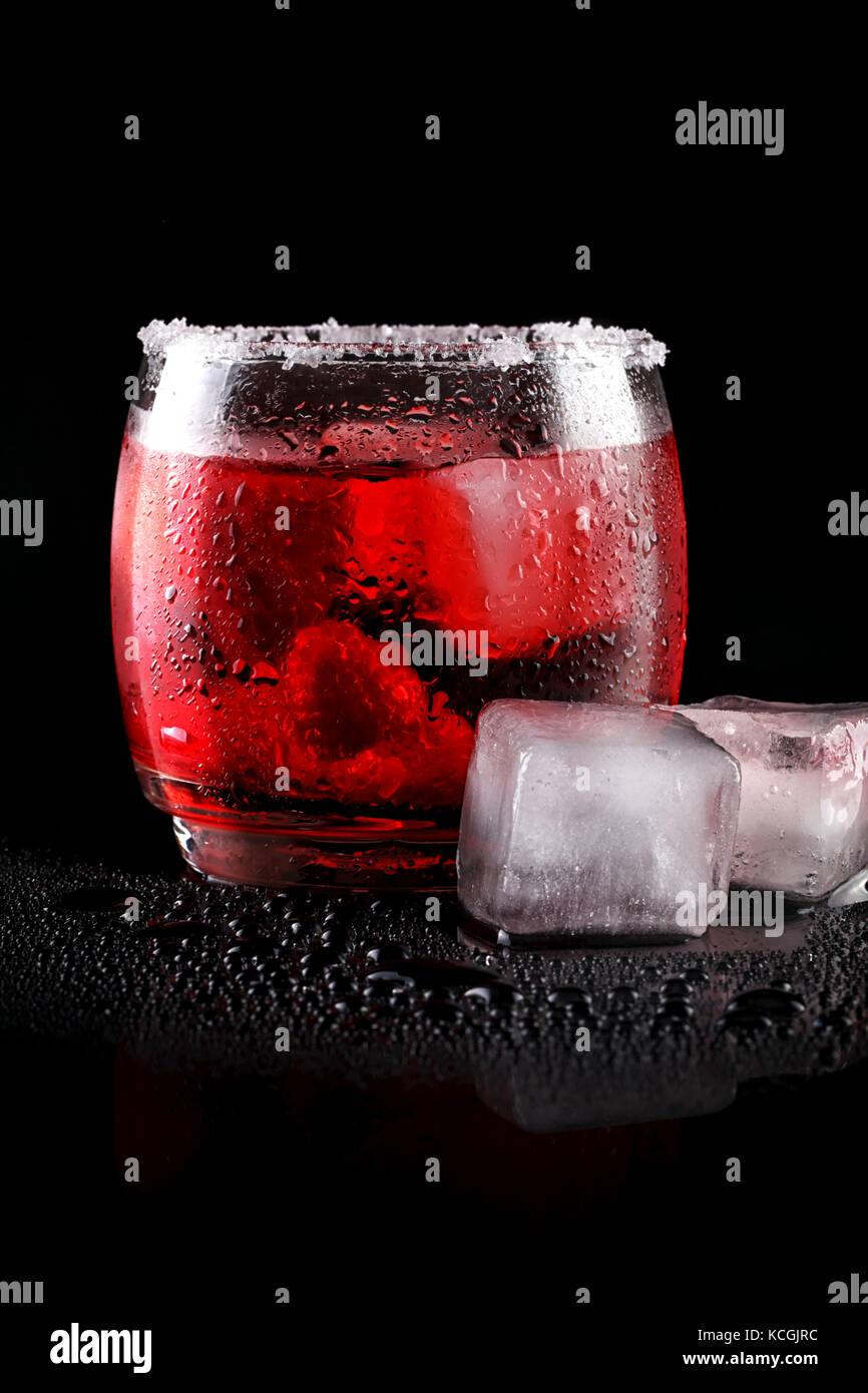 Ice cold red refreshing cocktail with lime on black background Stock ...