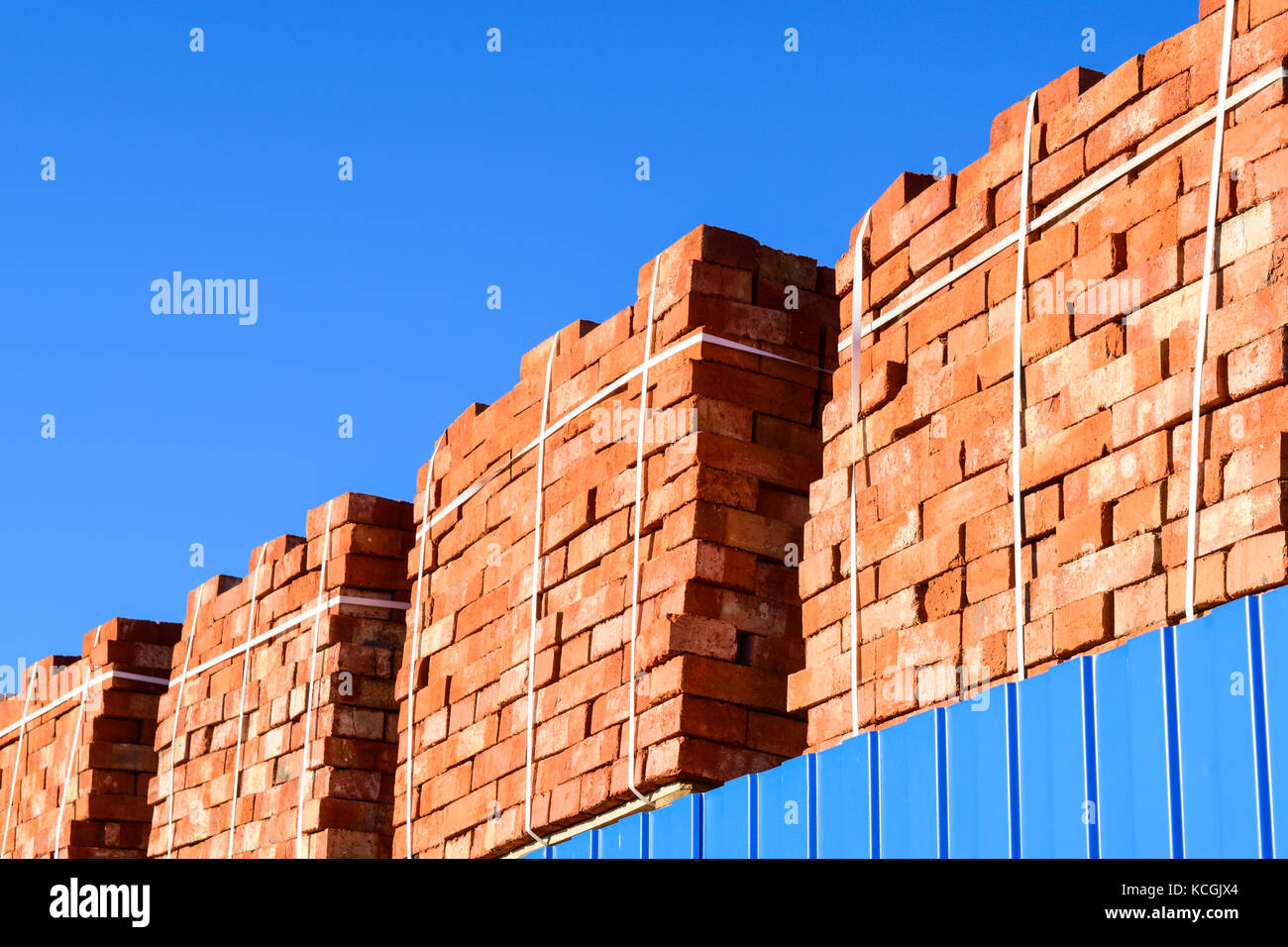 Red bricks stacked into cubes. Warehouse bricks. Storage brickworks ...