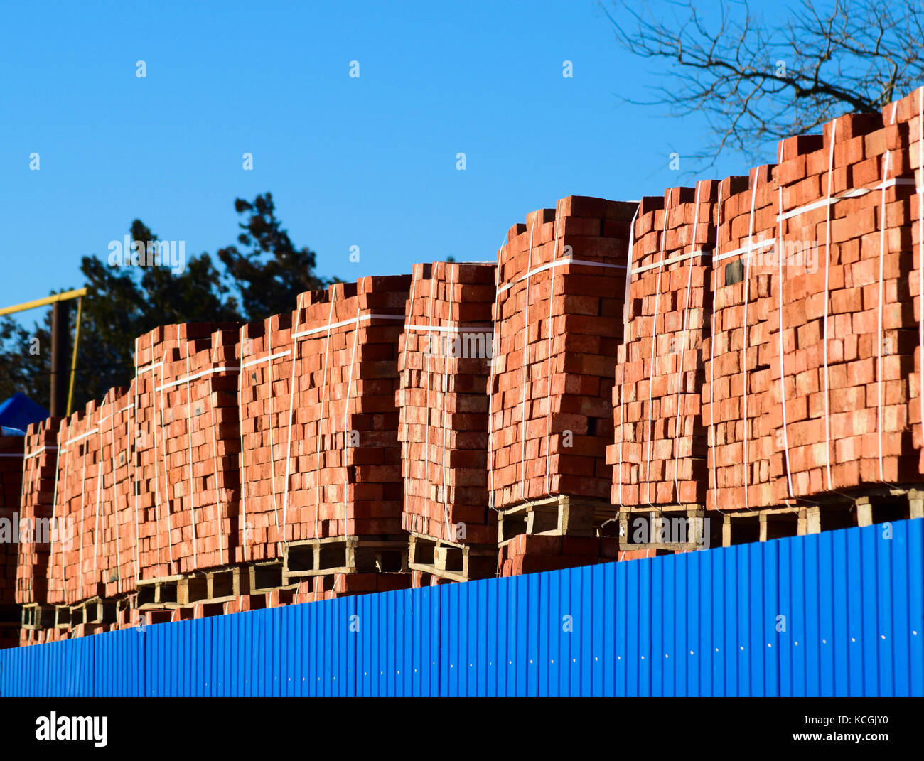 Red bricks stacked into cubes. Warehouse bricks. Storage brickworks ...