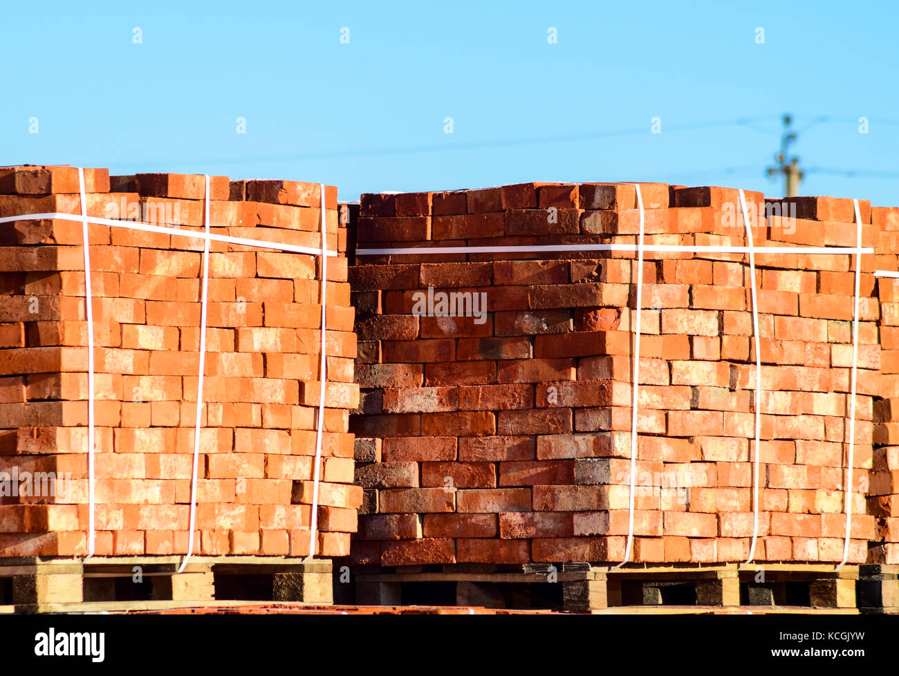 Red bricks stacked into cubes. Warehouse bricks. Storage brickworks ...