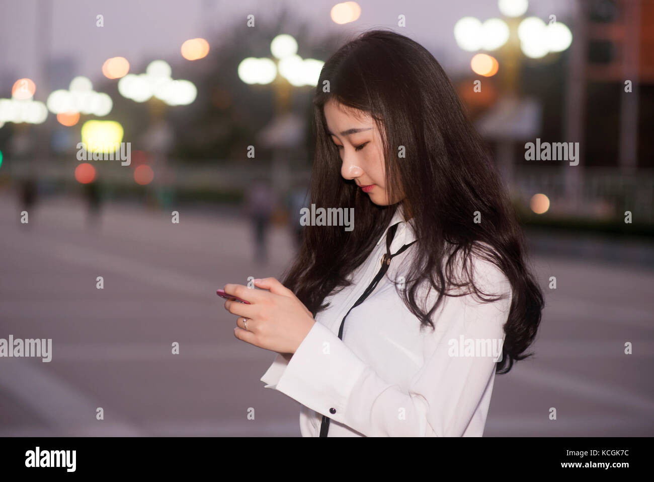 The young woman use a mobile phone at night Stock Photo - Alamy