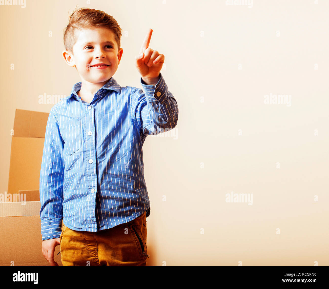 little cute boy in empty room, remoove to new house. home alone Stock ...