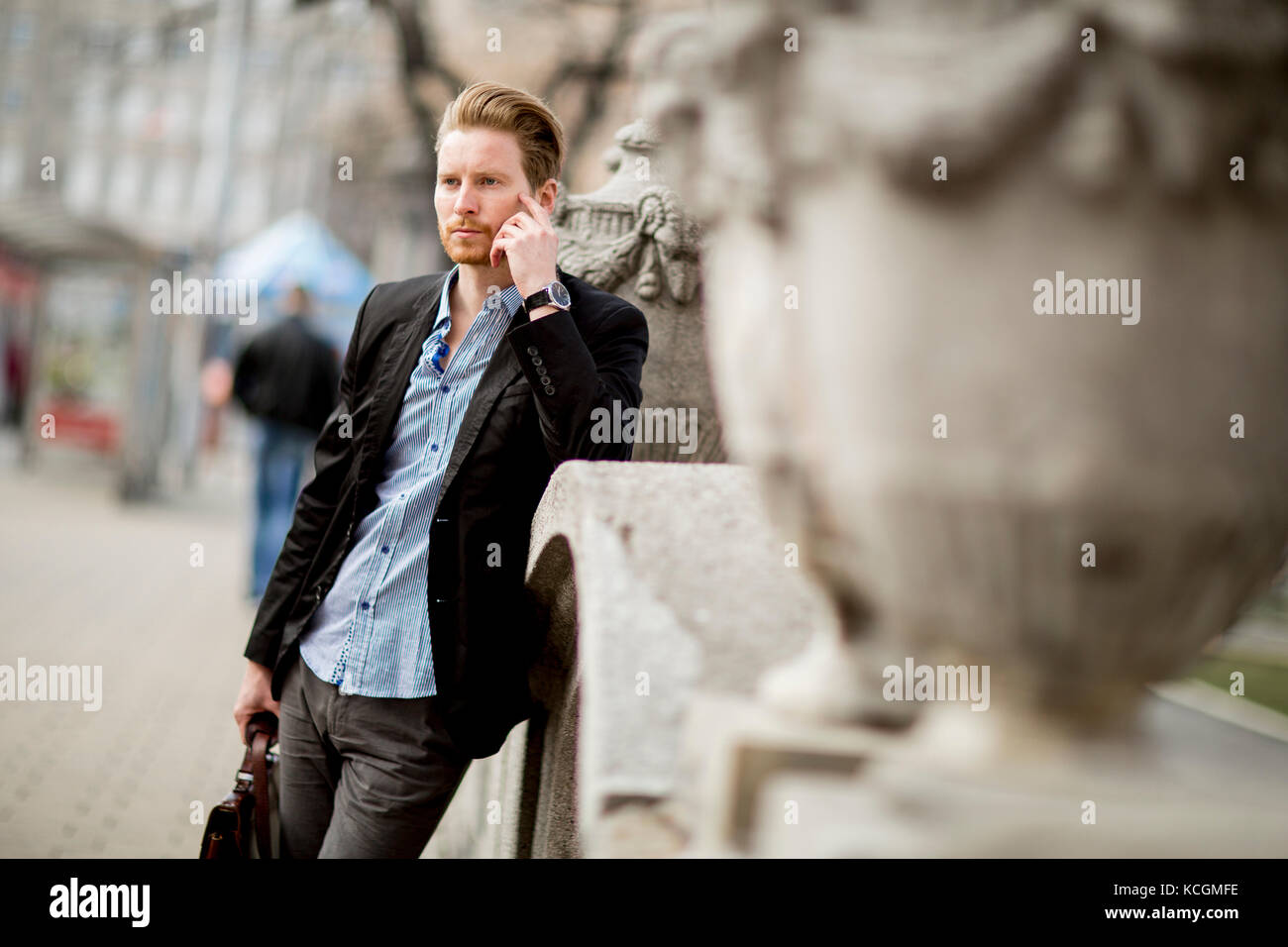 Handsome young man using mobile phone on the street Stock Photo - Alamy