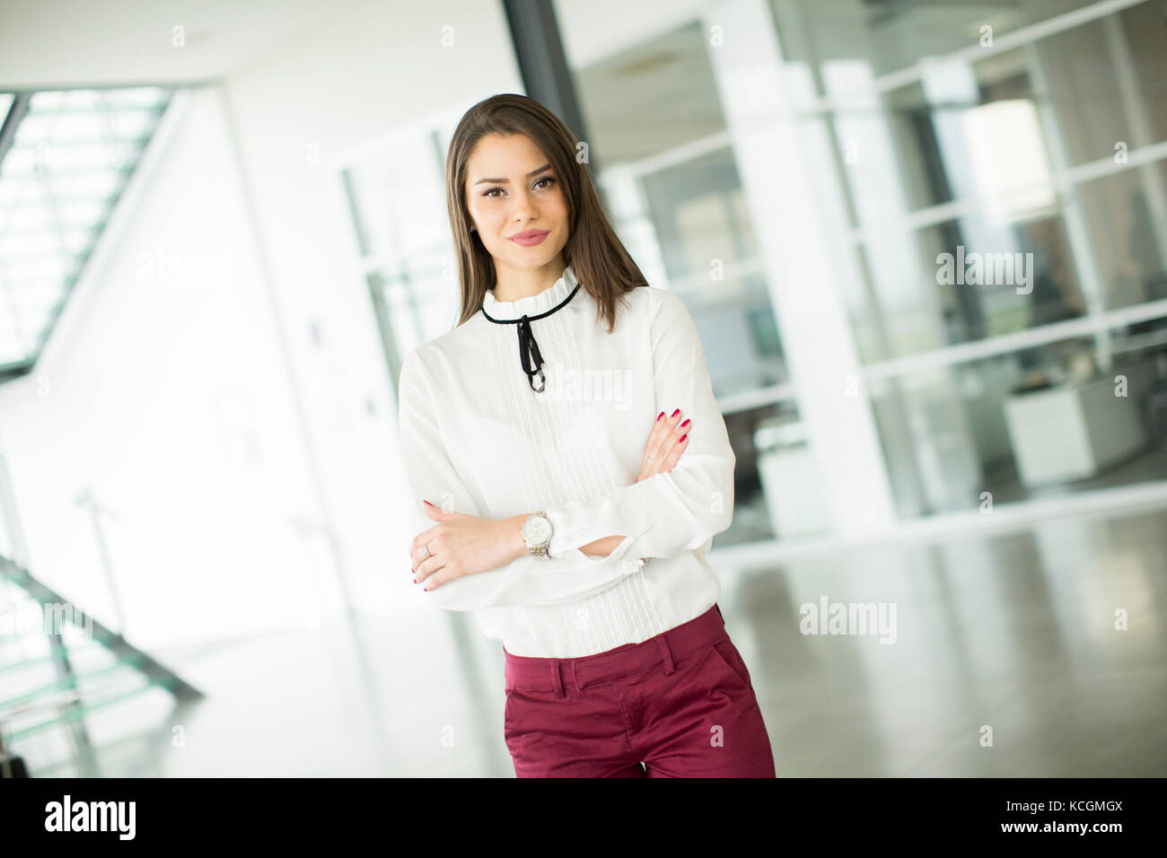Young female executive standing hi-res stock photography and images - Alamy