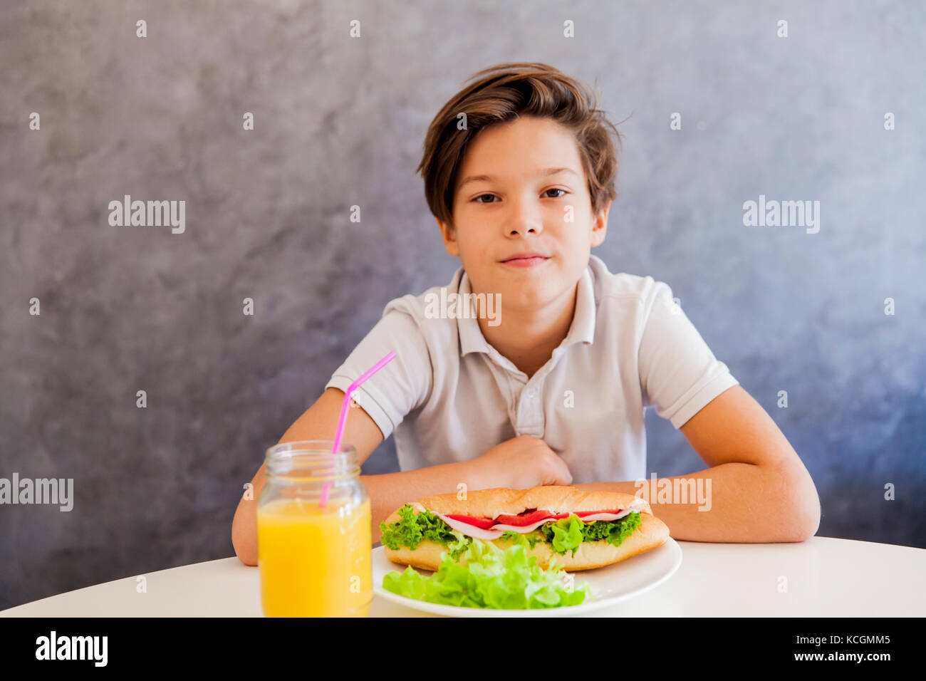 Portrait of cute teen boy having healthy breakfast at home Stock Photo ...