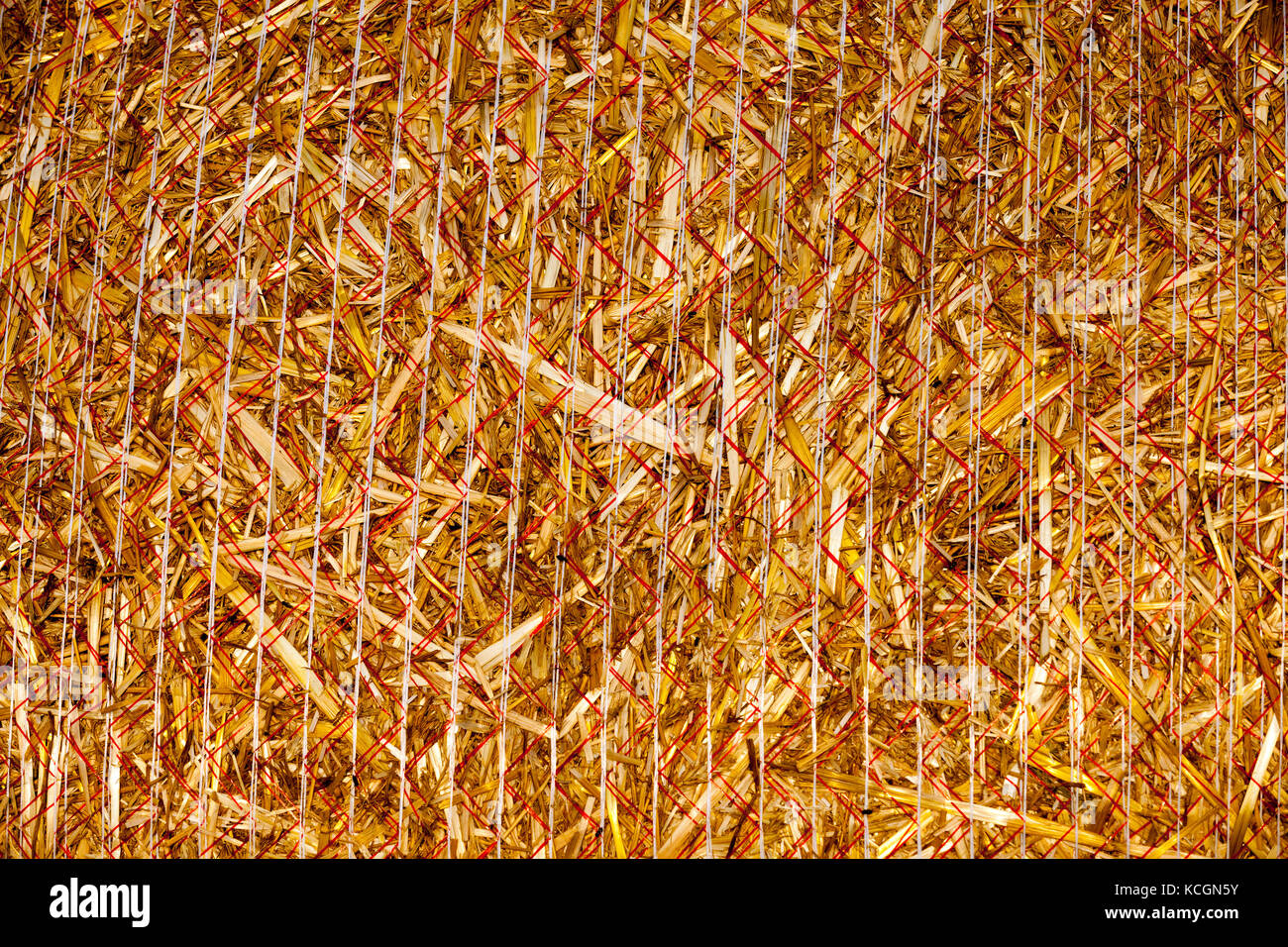 straw, connected by a yellow-red net, from which the stacks are made ...