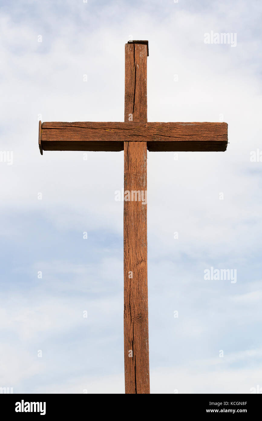 Old religious cross of wood against the blue sky. Photo close-up ...