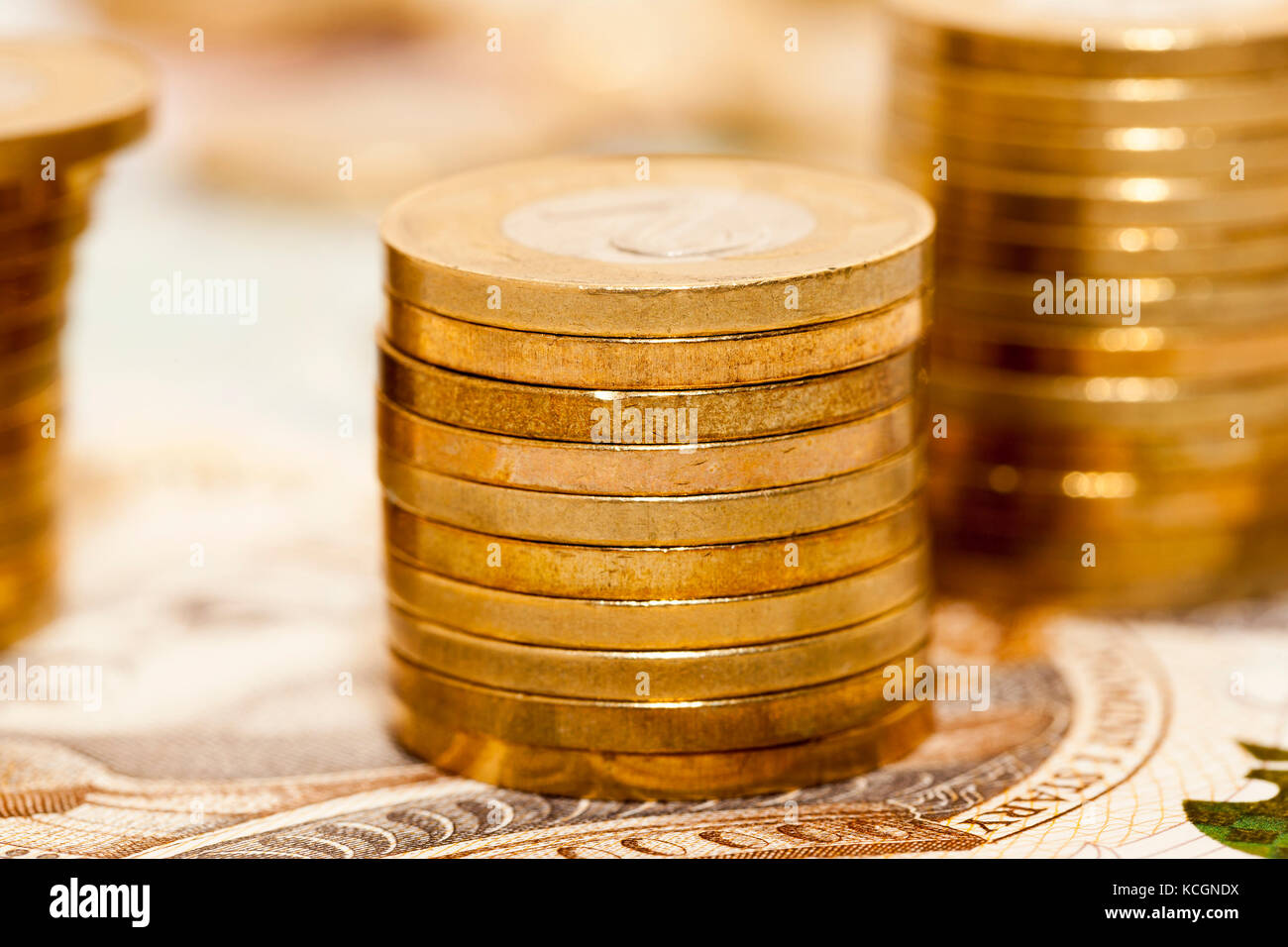 a pile of Polish coins lying on a paper money bill of Poland ...