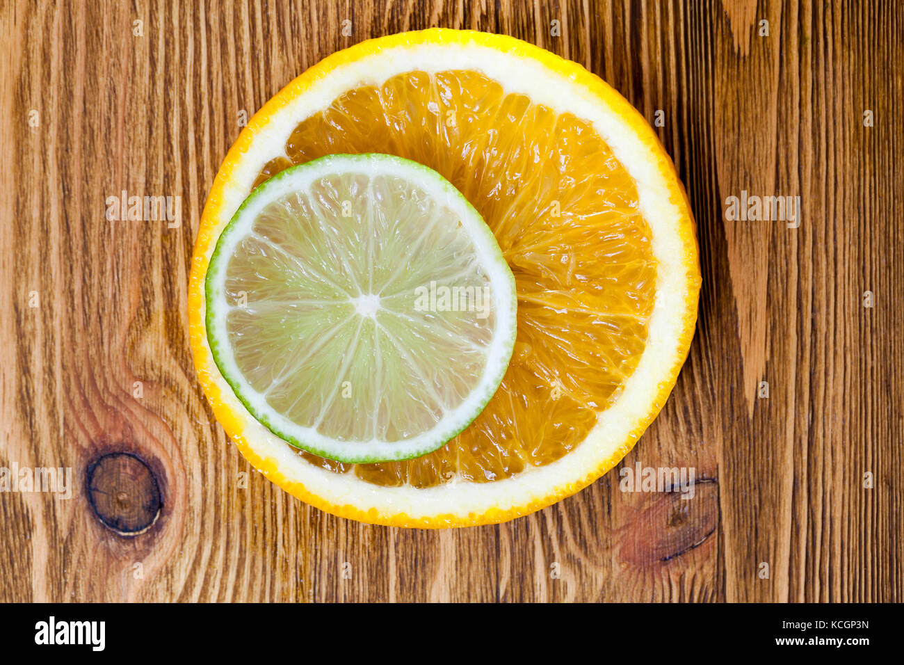cut slices of orange and lime, lying next to each other and ...