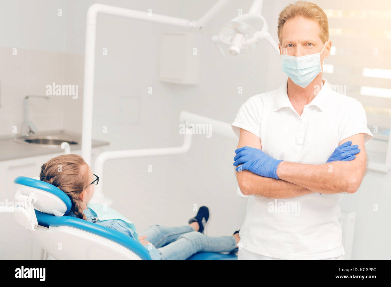Confident dental professional posing with his arms crossed Stock Photo ...