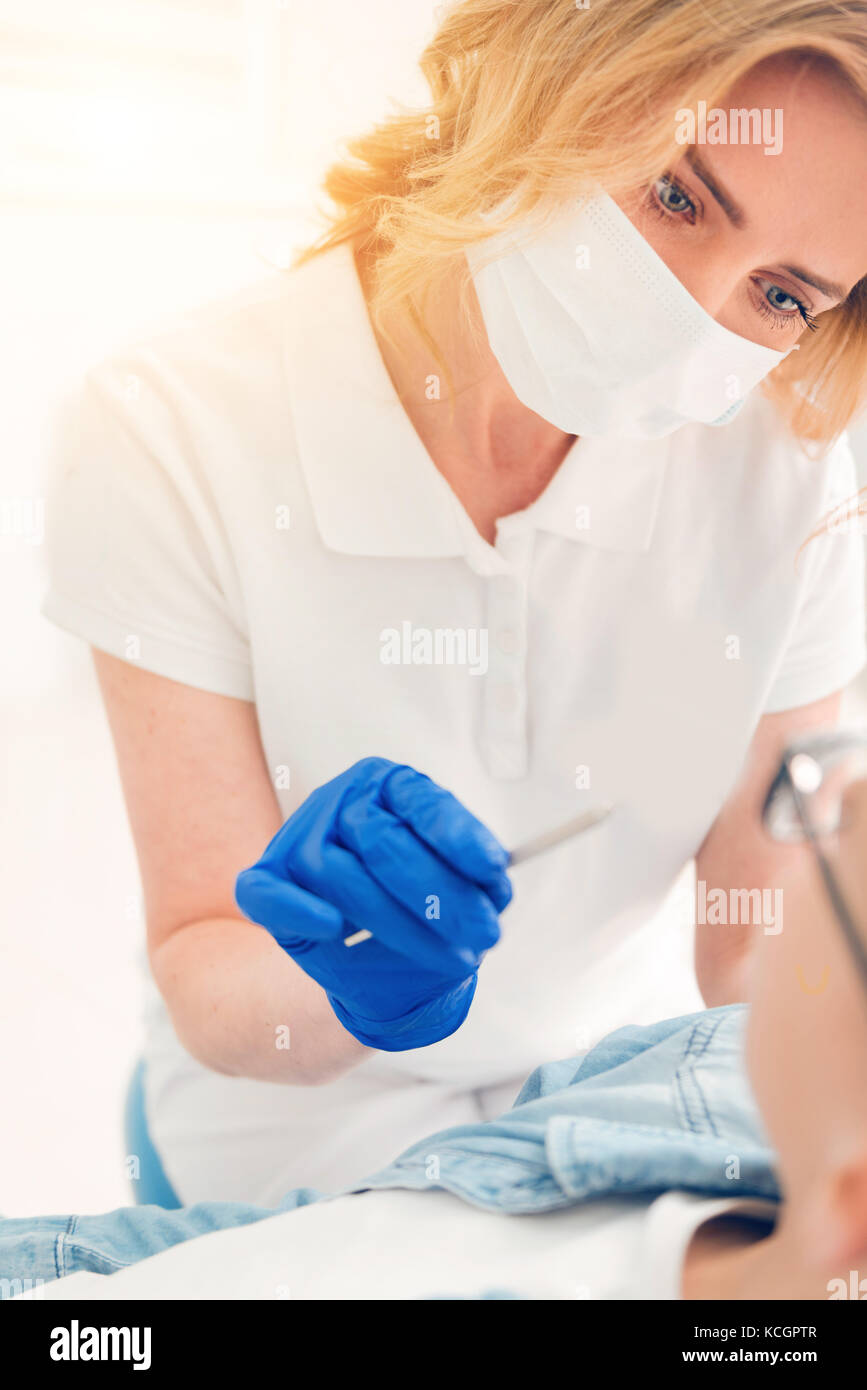 Female dental professional examining patient teeth Stock Photo - Alamy