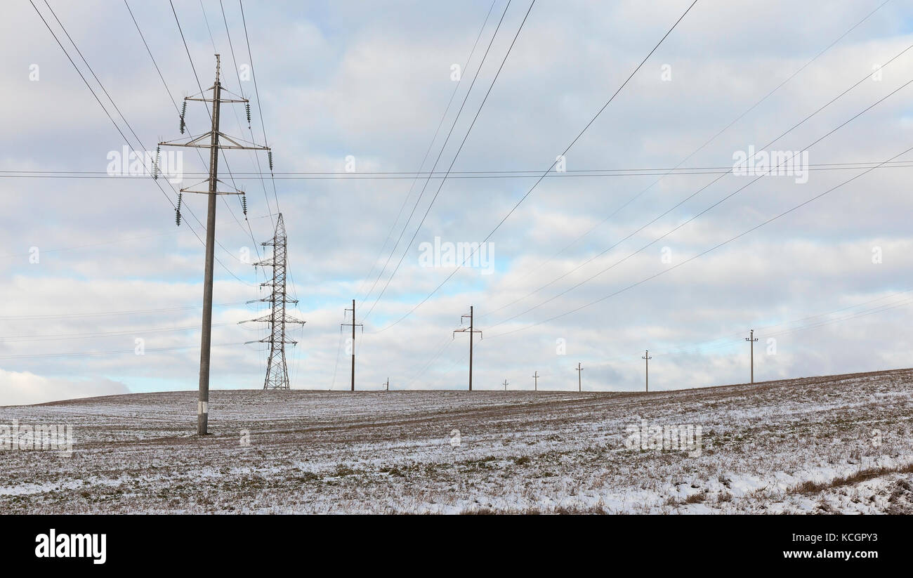 electric poles photographed in the winter season. On the ground is snow ...