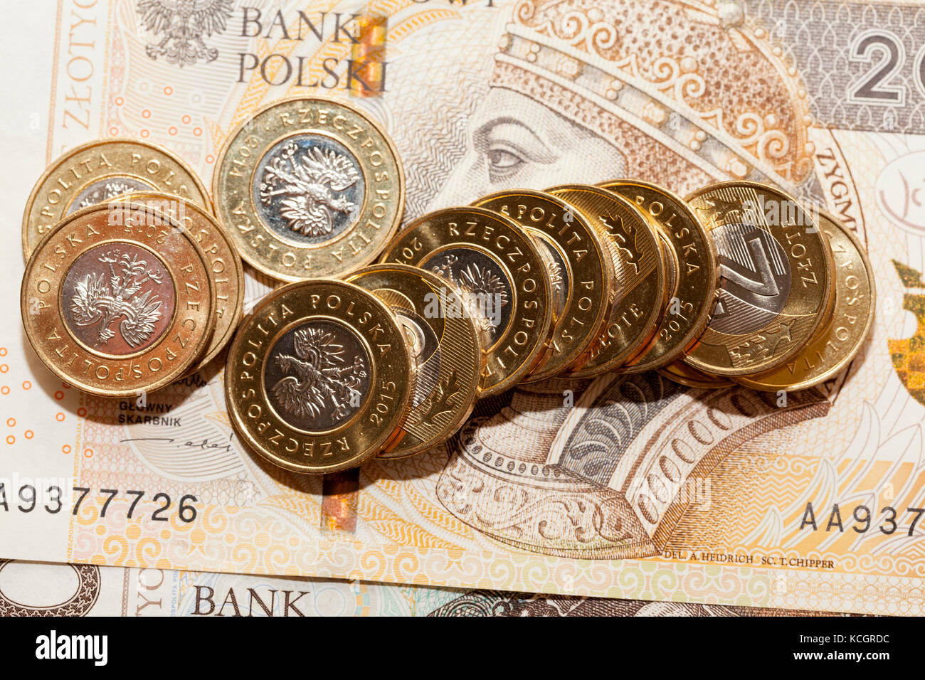 several Polish coins lying on paper currency signs of Poland ...