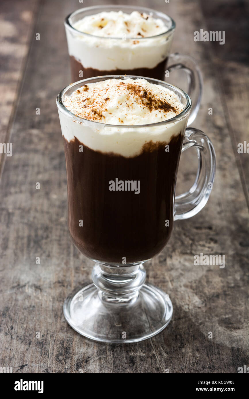 Irish coffee in glass on wooden table Stock Photo - Alamy