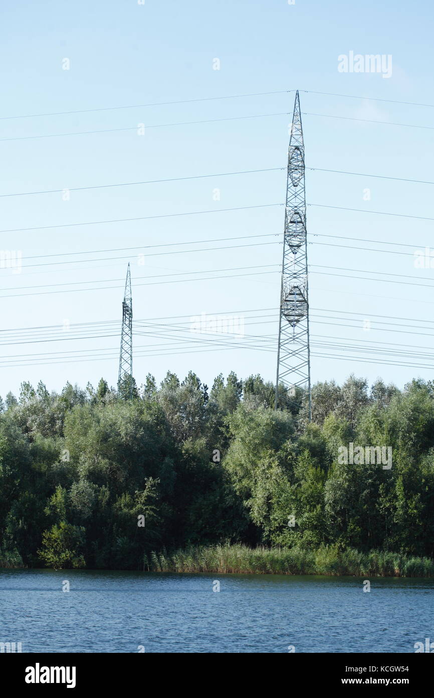 Electricity pylon or tower, Power Line on a lake Stock Photo - Alamy
