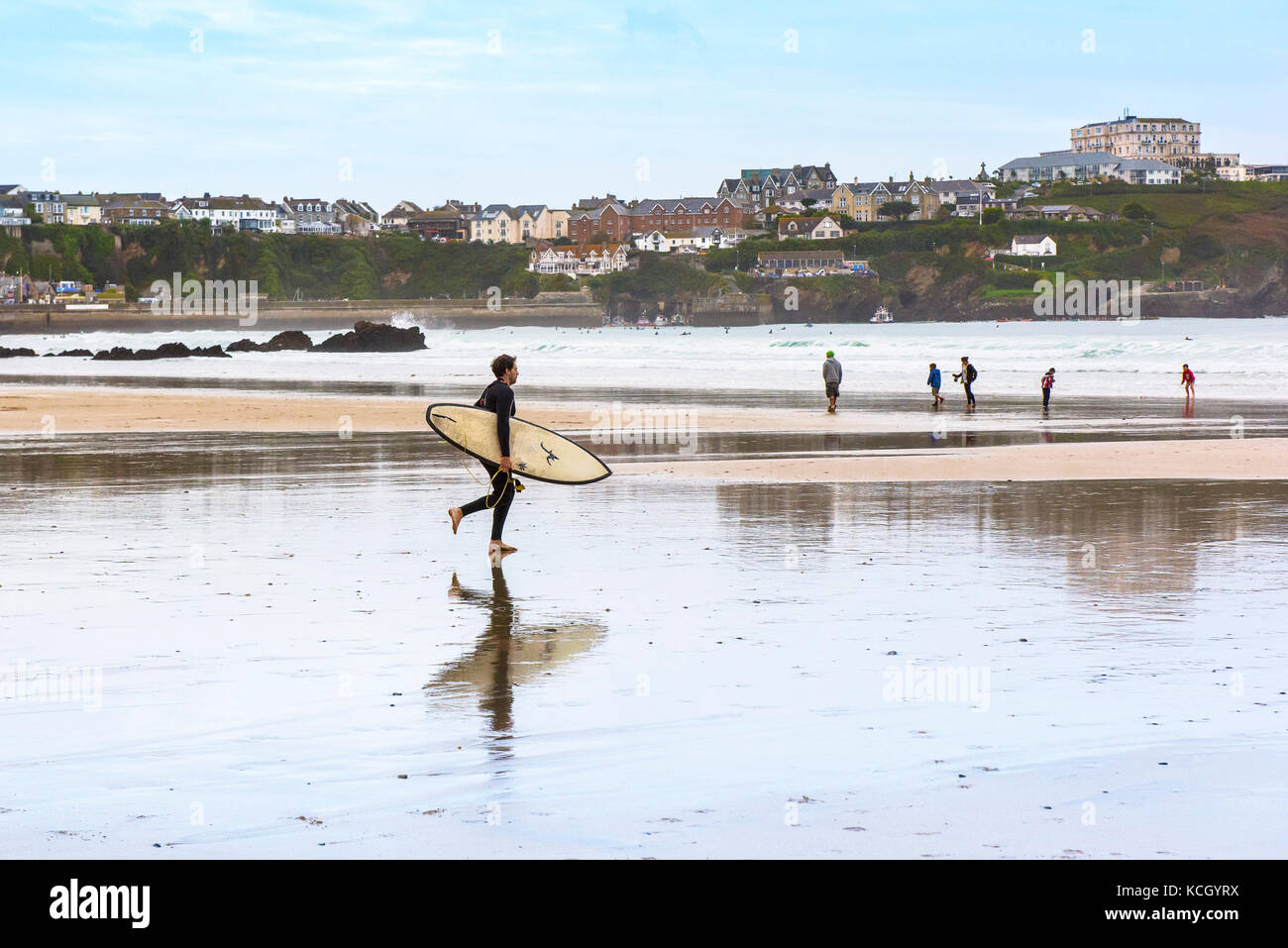 Surfers in Cornwall - a surfer running across the beach at Great ...