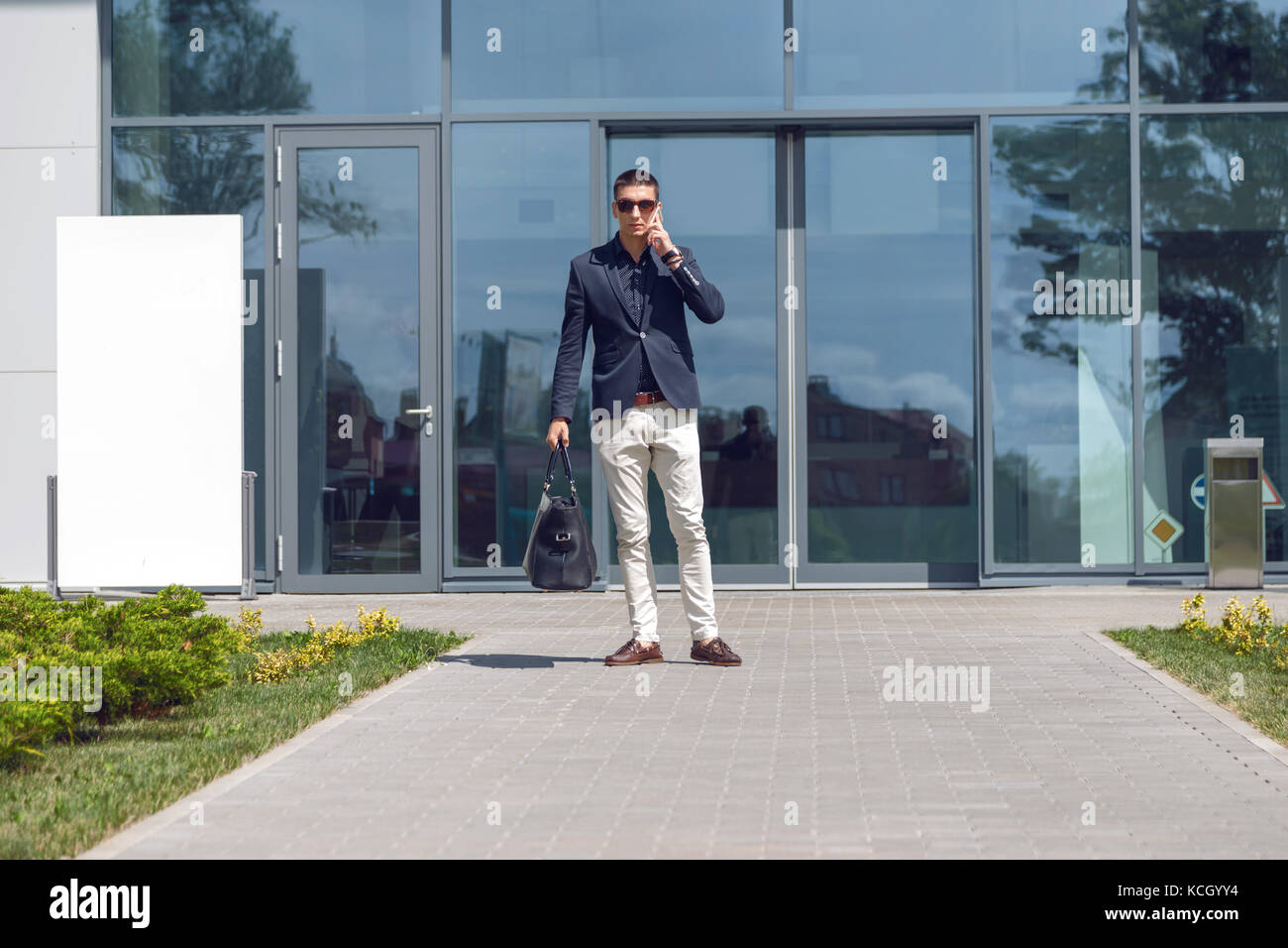Young official man expert calling via cell telephone while standing ...
