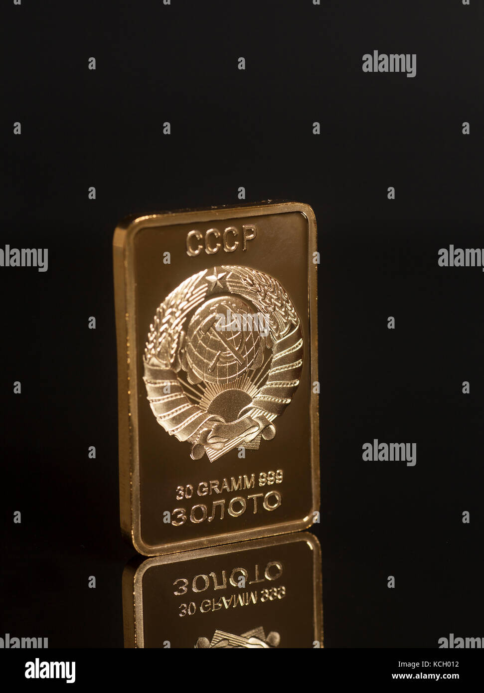Gold bullion with emblem of Soviet Union on black background Stock ...