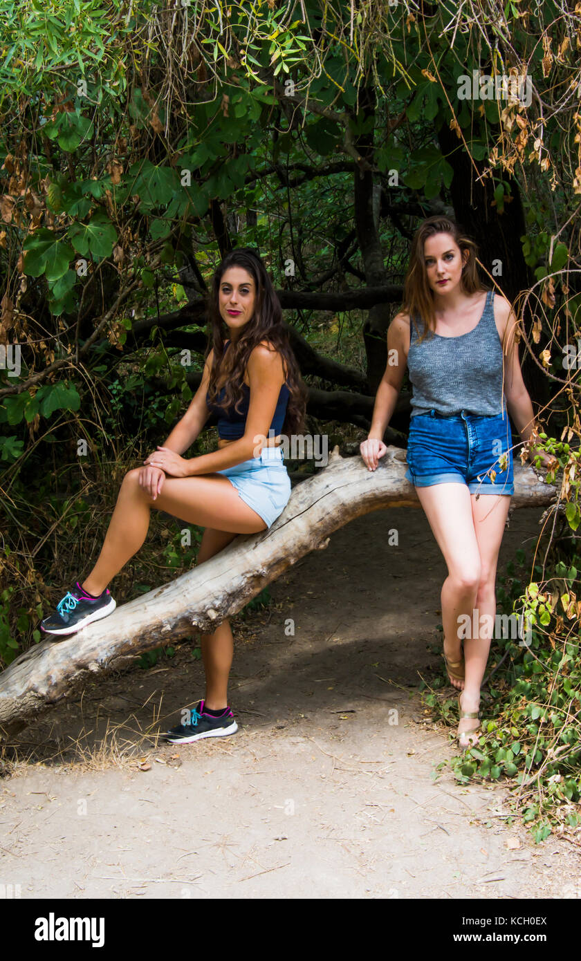 Two beautiful women hiking in nature on a mountain road Stock Photo - Alamy