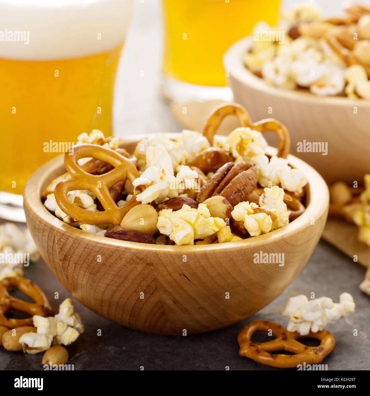 Homemade trail or snack mix with popcorn, pretzels and nuts with beer ...