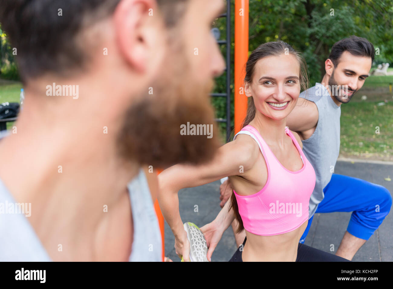 Attractive fit woman smiling during stretching routine while exe Stock ...