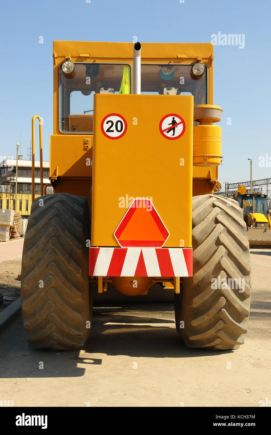 Yellow heavy construction machine up front Stock Photo - Alamy