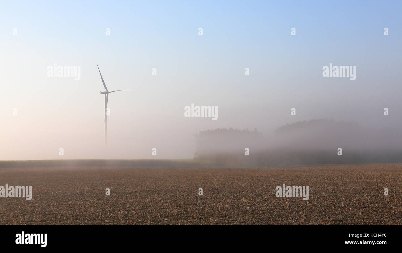 Wind turbine in the mist at dawn in southern Ontario Stock Photo - Alamy