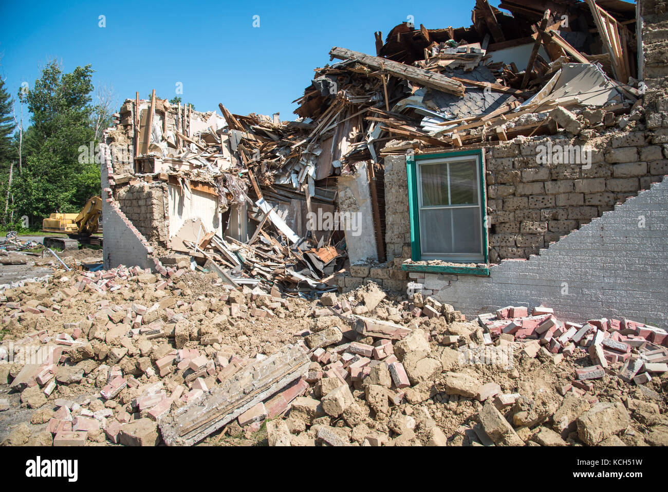 Rubble in front of an old mud brick building in the process of being ...